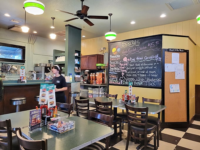 Inside, the classic diner vibe hits all the right notes—checkered floors, green-trimmed lights, and a specials board that reads like a love letter to hungry patrons.