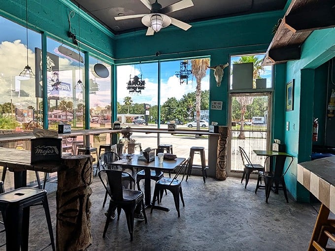 Turquoise walls and industrial-chic seating create the perfect backdrop for your taco feast – casual comfort with Florida flair.