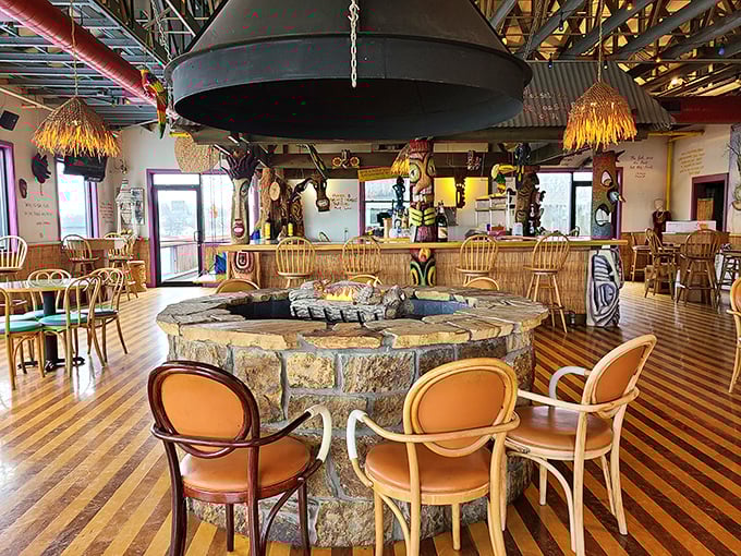 The heart of Pickle Bill's features a stone fire pit surrounded by cozy chairs – nautical charm meets fireside comfort in this whimsical dining space.