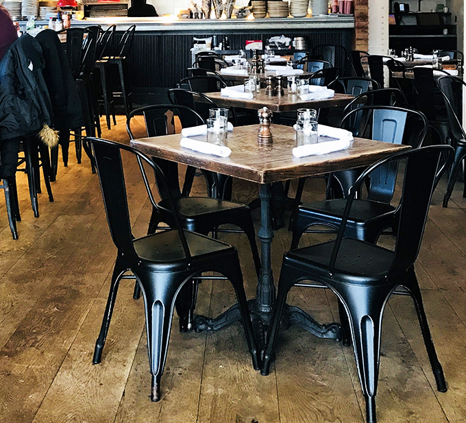 Industrial chic meets sandwich sanctuary. These metal chairs have witnessed countless "first bite" faces—that universal expression of cheesesteak enlightenment.