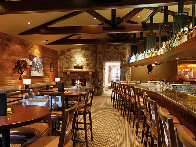 Inside, time slows down under exposed wooden beams and stone walls. The bar gleams with promise while leather chairs invite you to settle in for what might be the best meal of your week.