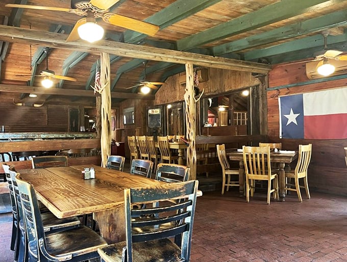 Where rustic meets refined – rough-hewn beams, wooden tables, and the Texas flag create the perfect backdrop for serious steak business.