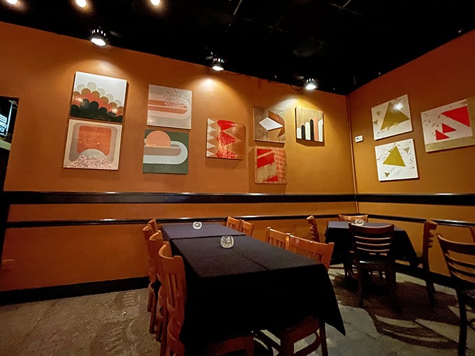 Warm orange walls adorned with modern art create the perfect backdrop for cheese-induced euphoria—like dining inside a cozy sunset with better seating.