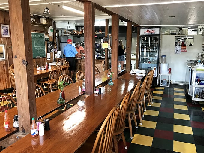 Long wooden tables with Windsor chairs invite communal dining under wooden beams – breakfast democracy in action at its finest.