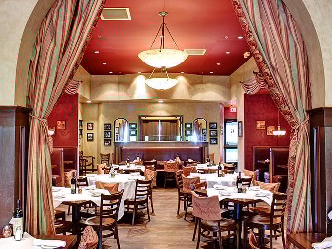 Step through the archway into a world where red ceilings, elegant drapery, and white tablecloths create the perfect backdrop for carb-laden love affairs.