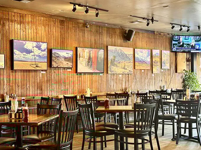 Wood-paneled walls adorned with landscape art create that rare atmosphere where both first dates and family reunions feel equally at home.