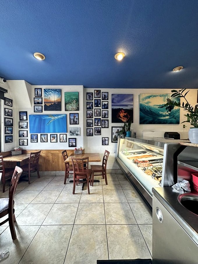 Ocean-blue ceiling, surf photography, and a gleaming seafood counter—this isn't decoration, it's a mission statement. Simplicity with purpose, like a perfectly grilled fish.