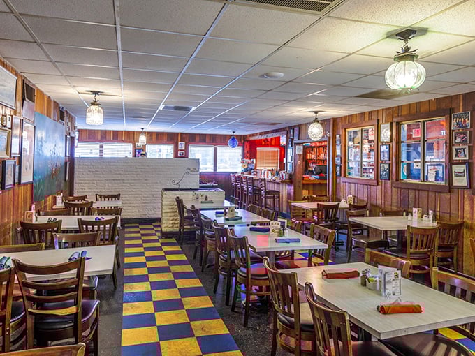 Wood paneling, checkerboard floors, and globe lights—this isn't retro design, it's authentic heritage preserved one satisfied customer at a time.