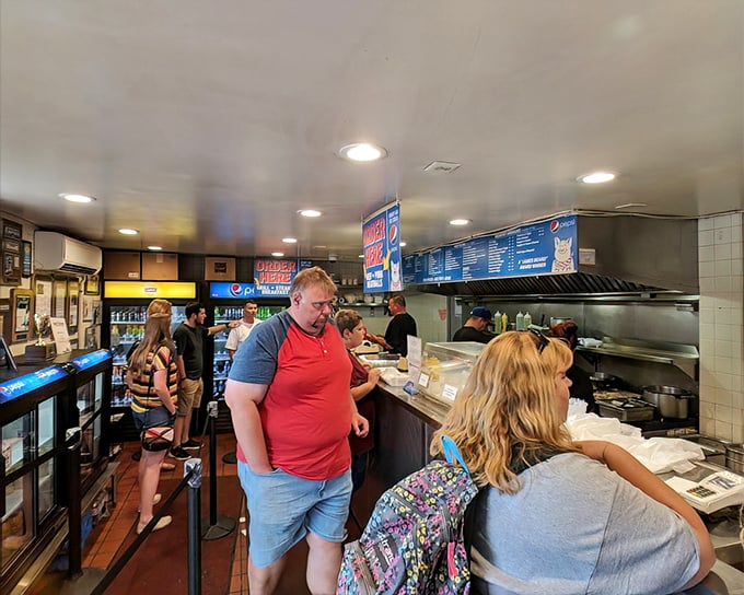 Inside, the organized chaos of lunchtime at John's is a beautiful dance—customers point, staff slice, and sandwich magic happens before your eyes.