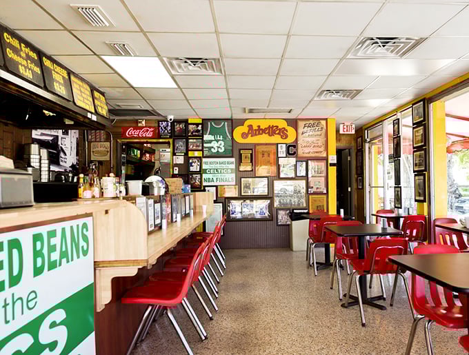 Red chairs, wood paneling, and walls filled with memories—this isn't interior design, it's hot dog history in the making.