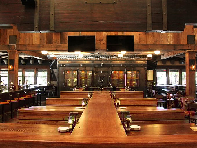 Rustic wooden beams meet modern industrial touches in this temple of smoke, where every table feels like the best seat in the house.