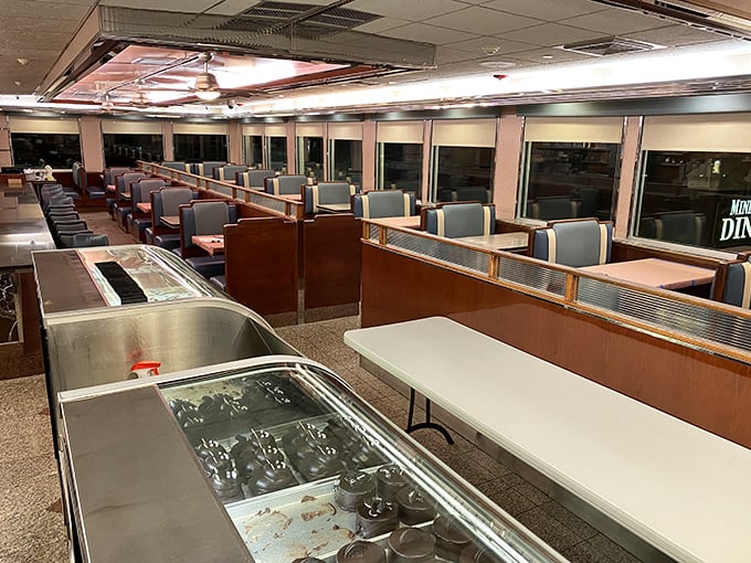 Classic diner geometry at its finest—teal booths, wood paneling, and that unmistakable counter where breakfast dreams come true.