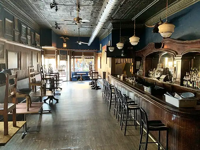 Step inside and the honky-tonk vibe is immediate – that gorgeous wooden bar, tin ceiling, and warm lighting create the perfect backdrop for serious meat appreciation.