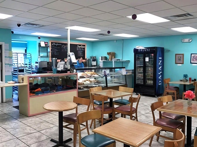 Turquoise walls and wooden tables create that perfect "stay awhile" vibe. The display case whispers sweet nothings to everyone who enters.
