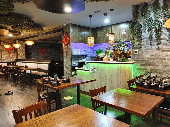 Inside, modern meets traditional with glowing green accents and hanging plants. It's like your cool aunt's living room, if she happened to make world-class dumplings.