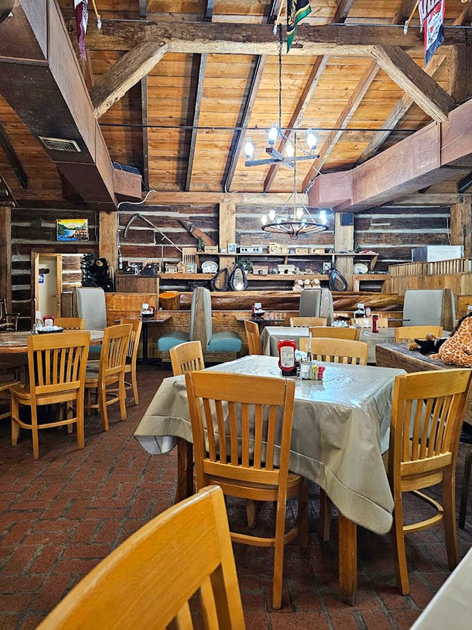 Exposed wooden beams and log walls create that authentic cabin feel—like you're eating breakfast in a Lincoln Log masterpiece.