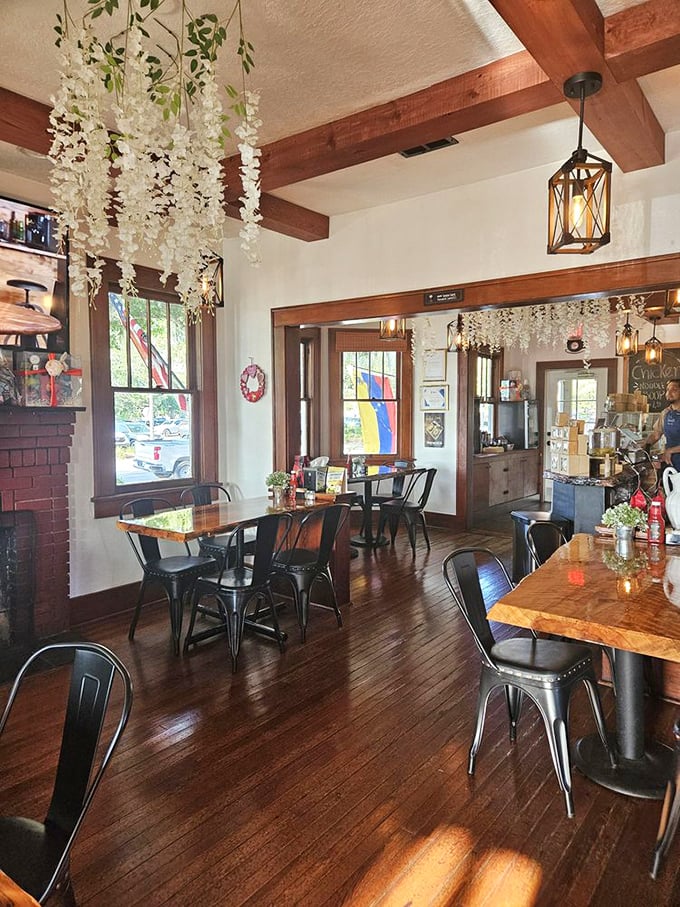 Hanging white floral garlands and warm wooden beams create an atmosphere that's both Instagram-worthy and genuinely cozy. The kind of place where coffee somehow tastes better.