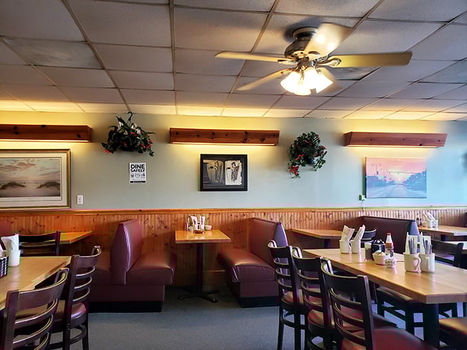 Cozy burgundy booths and warm wood paneling create the perfect backdrop for morning conversations. This isn't trendy décor—it's timeless diner comfort at its finest.