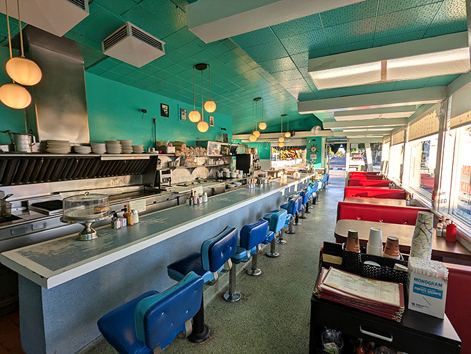 The diner time capsule: mint-green ceiling, blue counter stools, and red booths create the perfect symphony of nostalgic comfort.