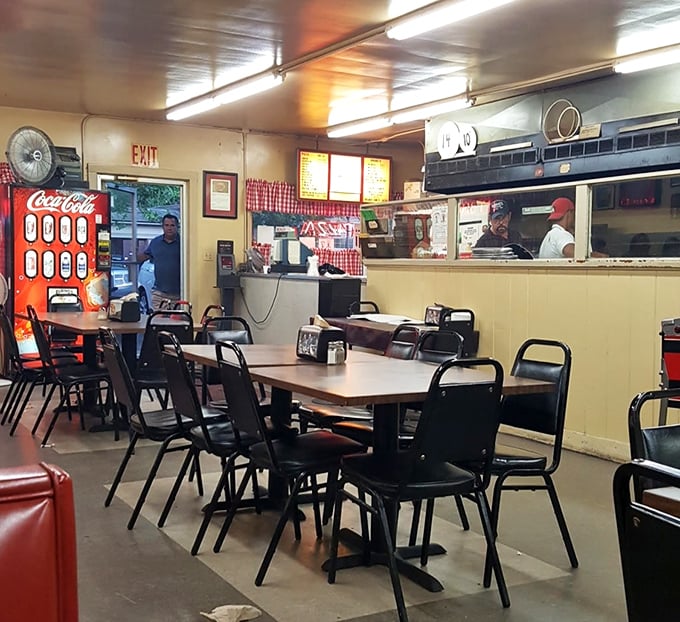 Inside Rubino's, fluorescent lighting illuminates a no-nonsense dining room where the focus is squarely on what matters most—that legendary thin-crust pizza.