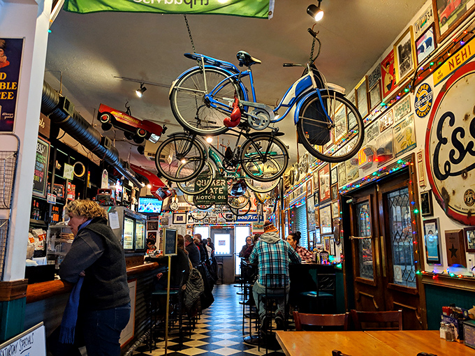 Step inside and time travel begins! Vintage bicycles suspended from the ceiling, walls plastered with memorabilia—this isn't decoration, it's a full-blown transportation museum with sandwiches.