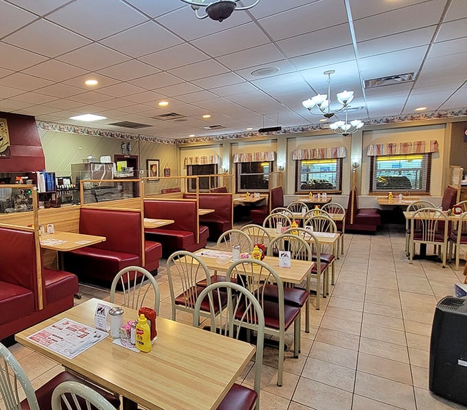 Classic diner perfection with red vinyl booths, wooden tables, and that unmistakable "regulars welcome" atmosphere that makes you instantly hungry.