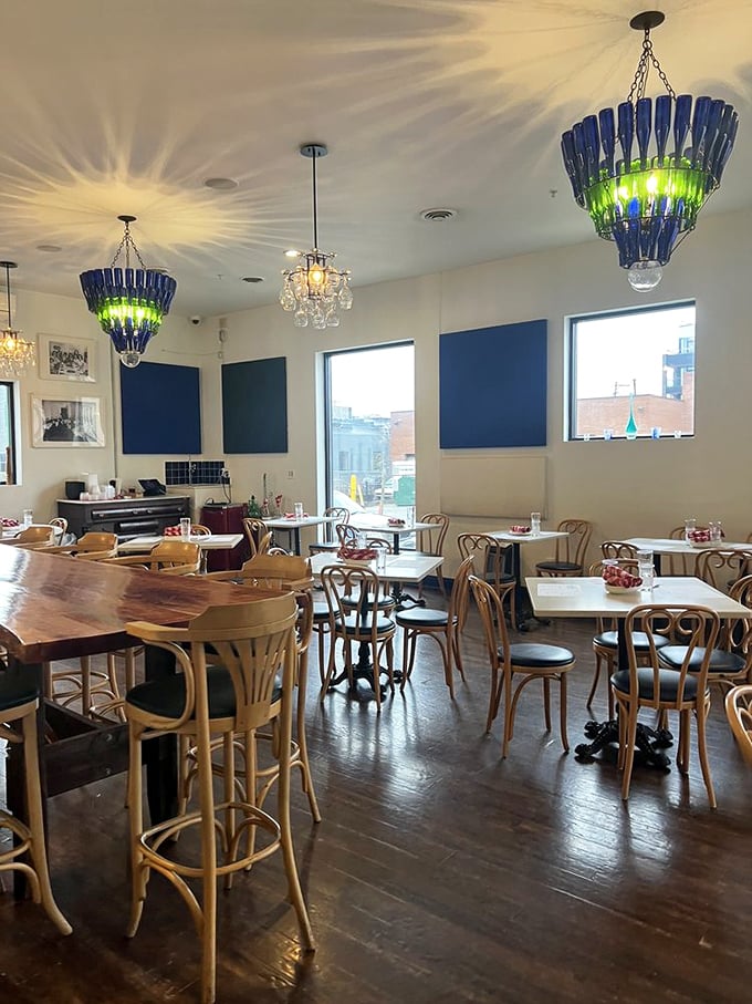Those blue bottle chandeliers aren't just lighting fixtures—they're conversation starters that cast magical patterns across DiAnoia's welcoming dining room.