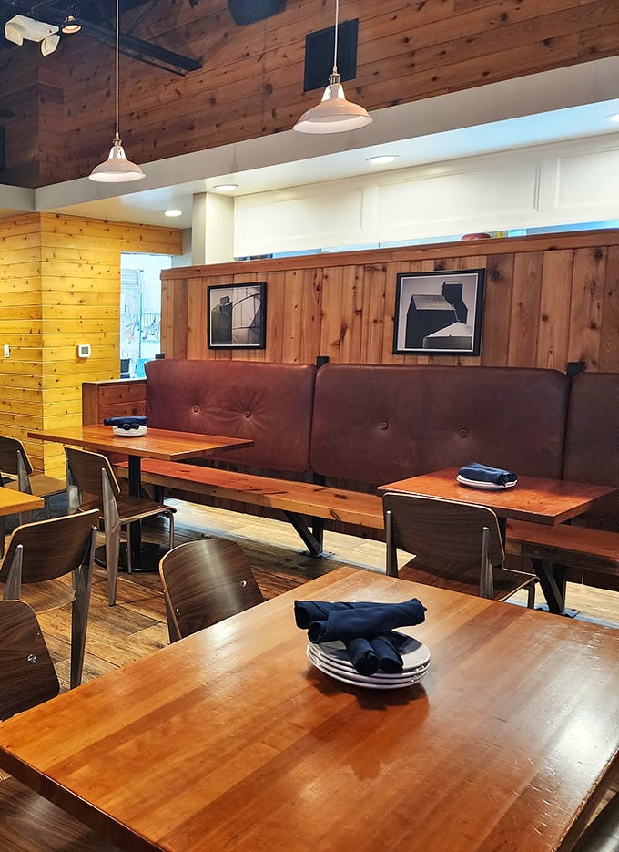 Rustic wooden walls meet modern design in this cozy interior where every table feels like the best seat in the house.