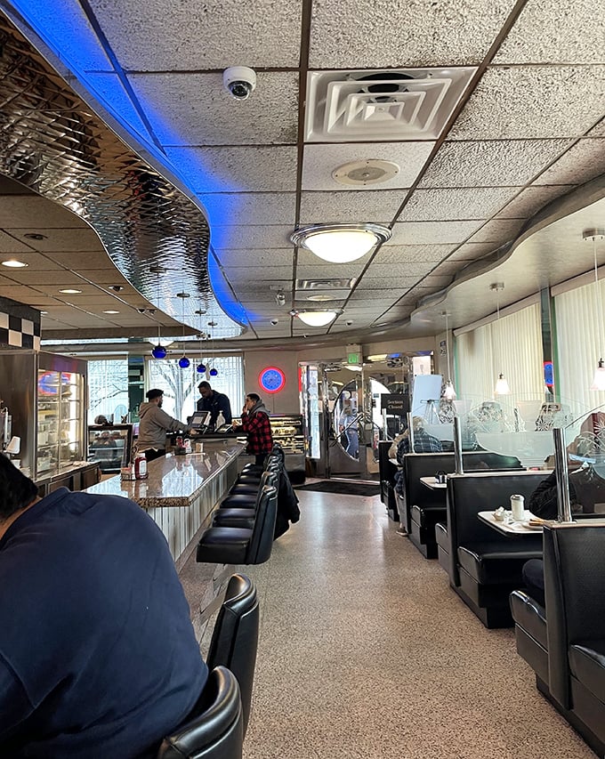Inside, the gleaming counter and blue accent lighting create the perfect backdrop for morning conversations and coffee refills that never seem to end.