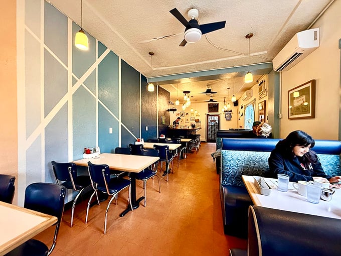 Inside The Mont, geometric blue walls and cozy booths create that rare atmosphere where both first dates and family reunions feel equally at home.