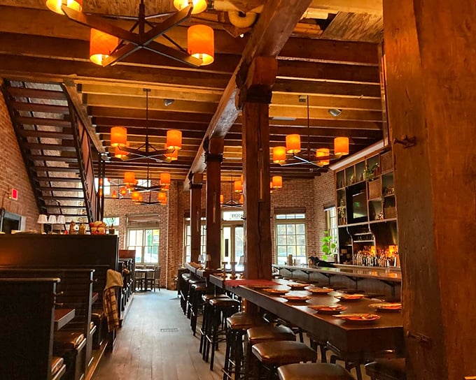 Wooden beams meet warm amber lighting in this transformed historic space, where every seat feels like you've scored the best table in the house.