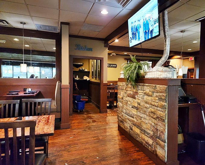 Warm wood paneling, stone accents, and that "Kitchen" sign promising good things ahead. This isn't just dining—it's like coming home to the family you actually want to see.