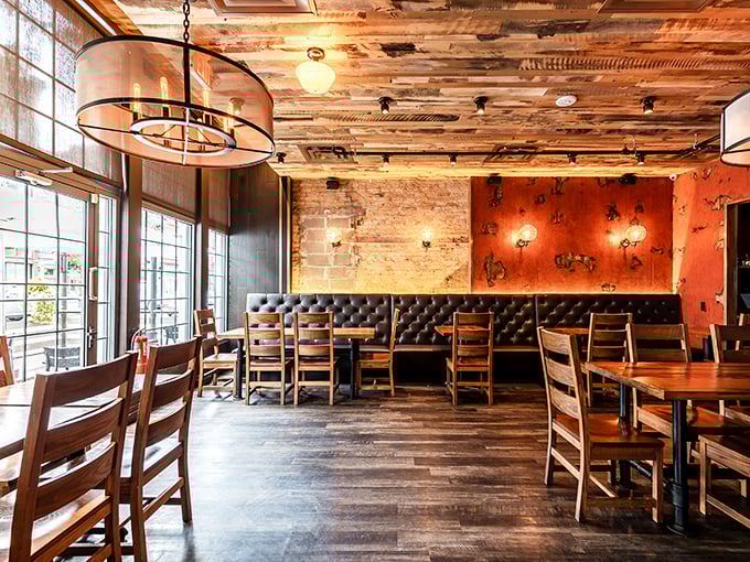 Reclaimed wood ceilings, exposed brick walls, and leather booths create the perfect backdrop for the comfort food drama about to unfold.