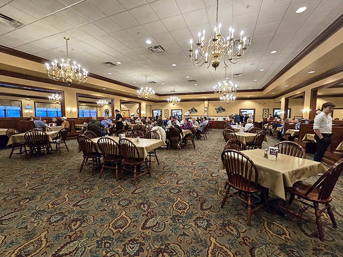 Crystal chandeliers and Windsor chairs create an atmosphere where comfort food meets unexpected elegance beautifully.
