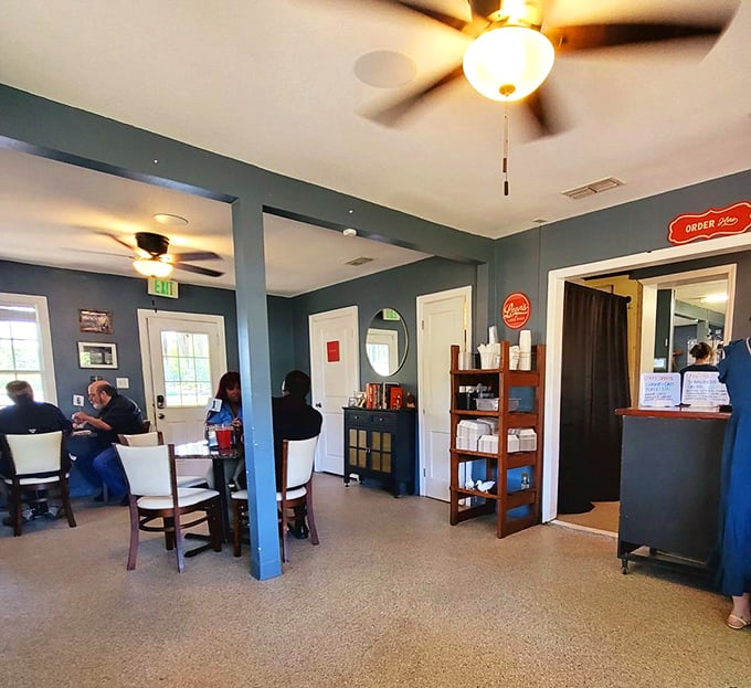 Blue-gray walls and ceiling fans create the perfect backdrop for conversations that flow as easily as sweet tea.