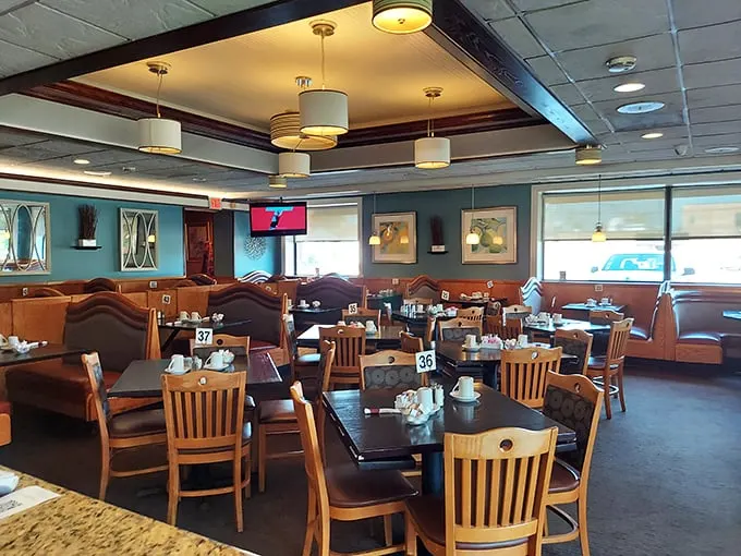 Cozy booths, warm lighting, and teal walls create the perfect backdrop for morning conversations. This dining room has witnessed countless "I needed this" moments.