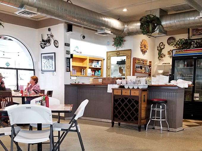 Inside, exposed ductwork meets eclectic wall art in a space that prioritizes good food over fancy frills.
