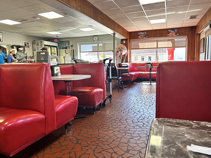 Cherry-red vinyl booths and wood-paneled walls create that perfect time capsule atmosphere where the decor hasn't changed because the barbecue never needed to.