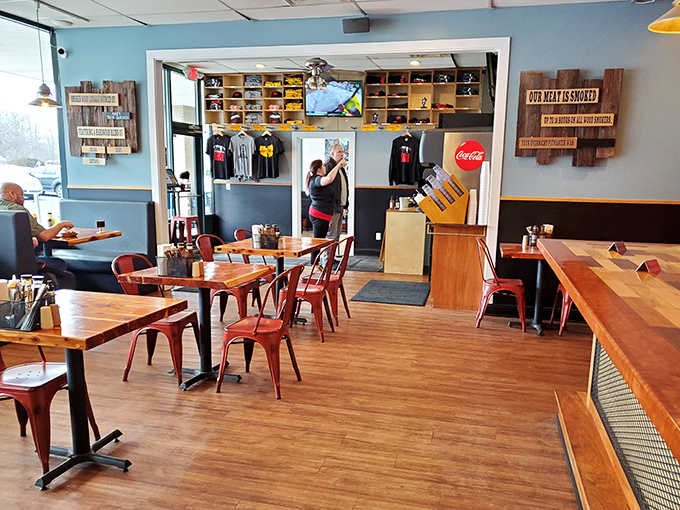 Simple wooden tables, metal chairs, and that "Our Meat Is Smoked" sign – because sometimes the most important truths need to be displayed on the wall.