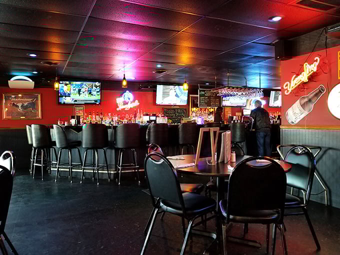 The bar area strikes that perfect balance—dark enough for intrigue, bright enough to see your food, with just the right amount of sports on TV.