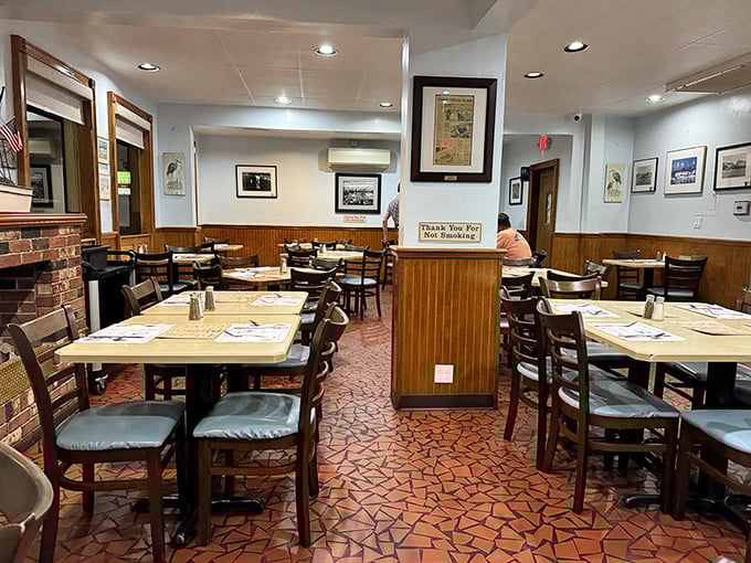 Simple wooden chairs, nautical-themed placemats, and that distinctive terracotta floor—dining room perfection that hasn't needed updating in decades.