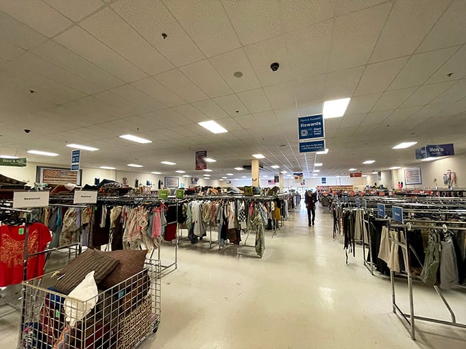Clothing racks stretch toward infinity, a textile galaxy where fashion from every decade awaits its second chance at stardom.