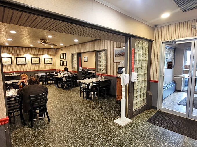 Classic diner aesthetics with glass block dividers and terrazzo flooring create that perfect "I've been coming here since before you were born" vibe.