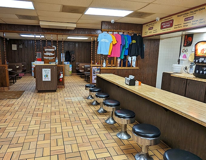 Step inside and time stands still – wood paneling, swivel stools, and the promise of handcrafted donuts that would make Homer Simpson weep with joy.