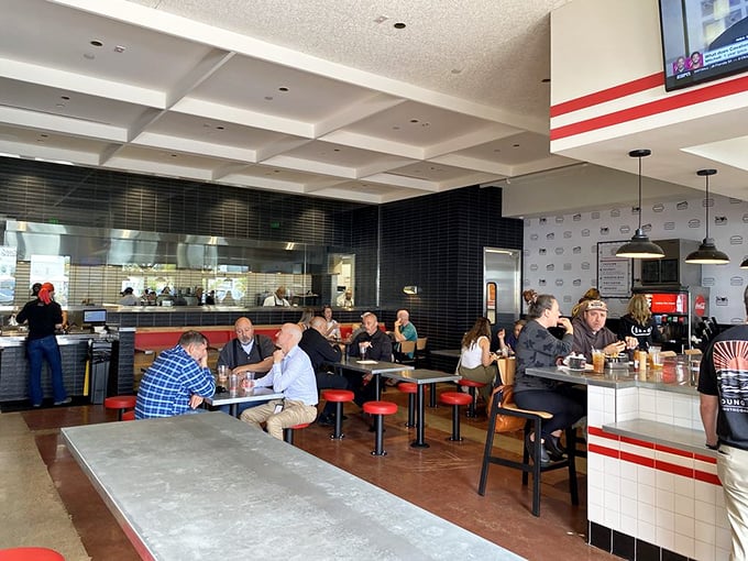 Modern minimalism meets burger paradise. The clean interior with its red accents and communal tables creates the perfect stage for the star of the show—the food.