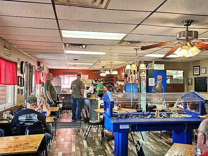 Inside, wooden tables and ceiling fans create the perfect small-town atmosphere where conversations flow as freely as the coffee. No designer needed—this is authentic Americana.