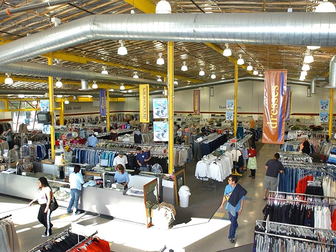 A retail wilderness where fashion dreams roam free. Rows upon rows of potential wardrobe transformations await beneath industrial ceilings and bright lights.