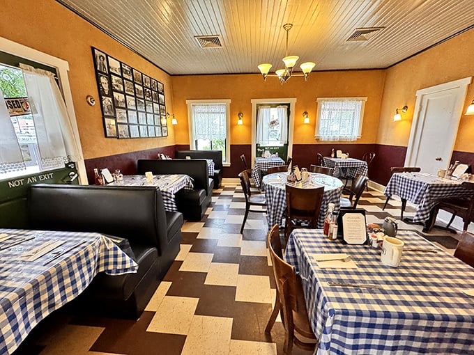 Inside, golden walls meet burgundy wainscoting while blue gingham tablecloths add homey charm. The checkered floor seems to whisper, "You're not in prison anymore, Dorothy."