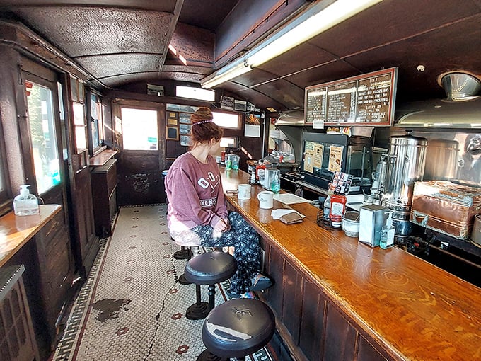 The narrow interior isn't cramped—it's intimate. Every inch tells a story, every stool has supported decades of hungry Natick residents.