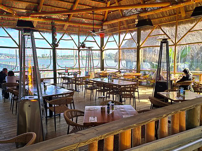 Dining under a thatched roof with water views? This isn't vacation—it's Tuesday in Florida if you're lucky enough to snag a table here.
